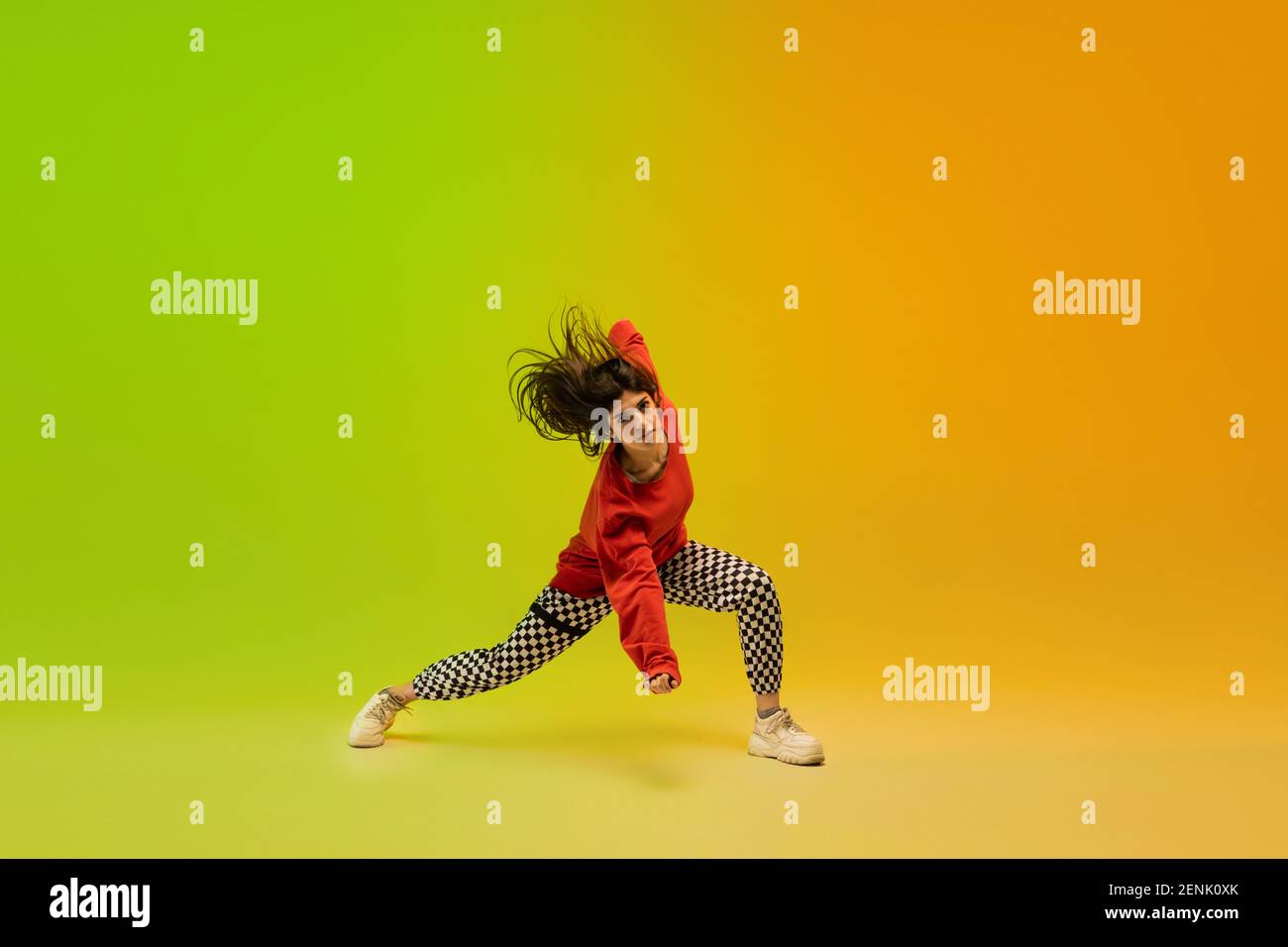 Energy. Stylish sportive girl dancing hip-hop in stylish clothes on ...