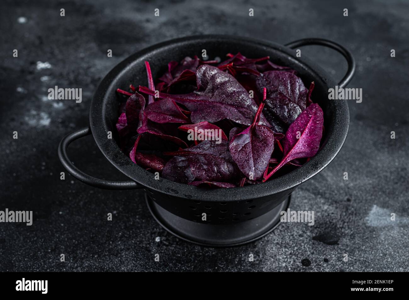 Leaves of Swiss red chard or Mangold salad in a colander. Black ...