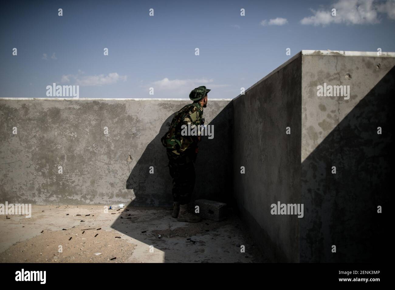 A UN-backed Government of National Accord fighter takes cover during ...
