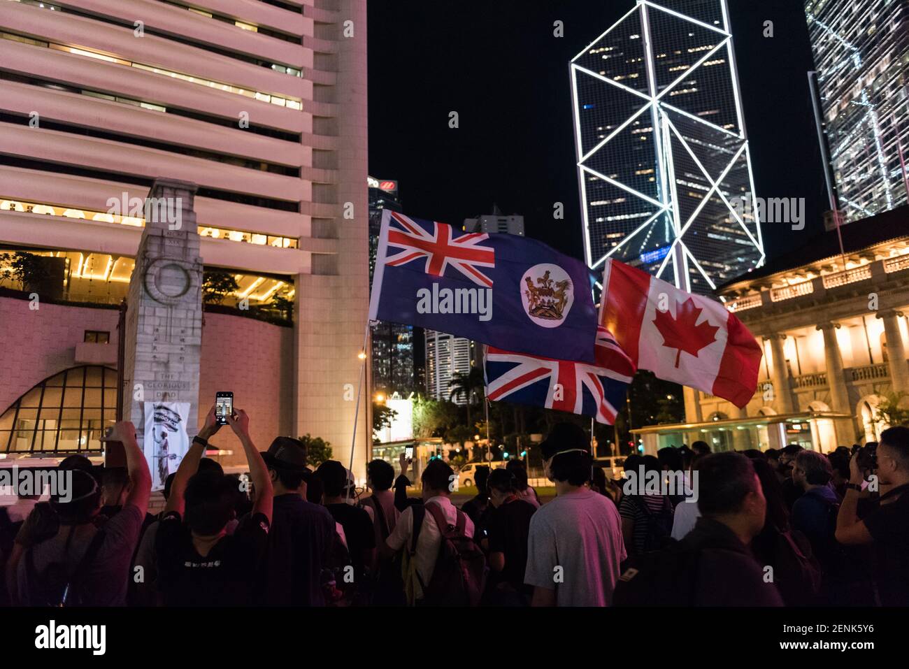 Protesters wave the flags of nations with a history of British ...