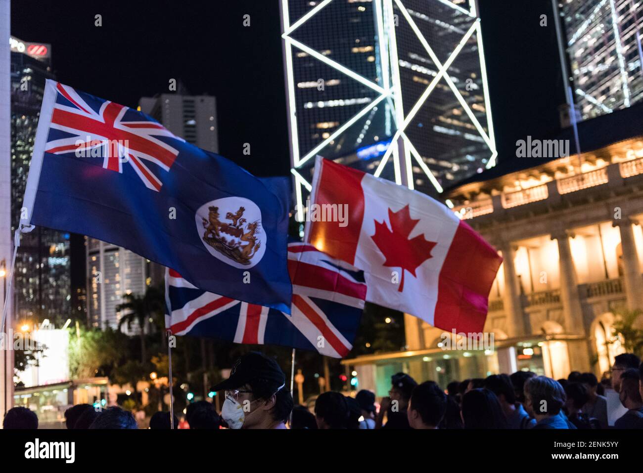Protesters wave various flags of nations with a history of British ...