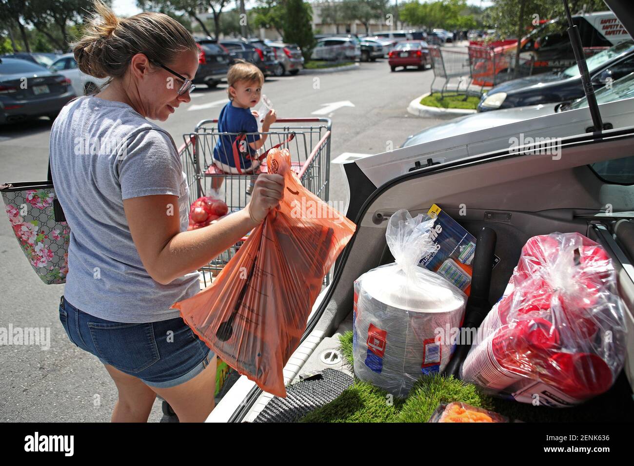 Gloria Thompson loads hurricane supplies into her car outside of Costco ...