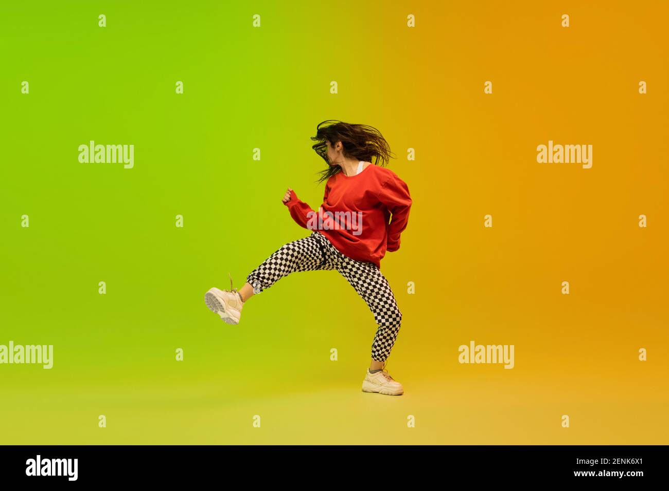 Action. Stylish sportive girl dancing hip-hop in stylish clothes on ...