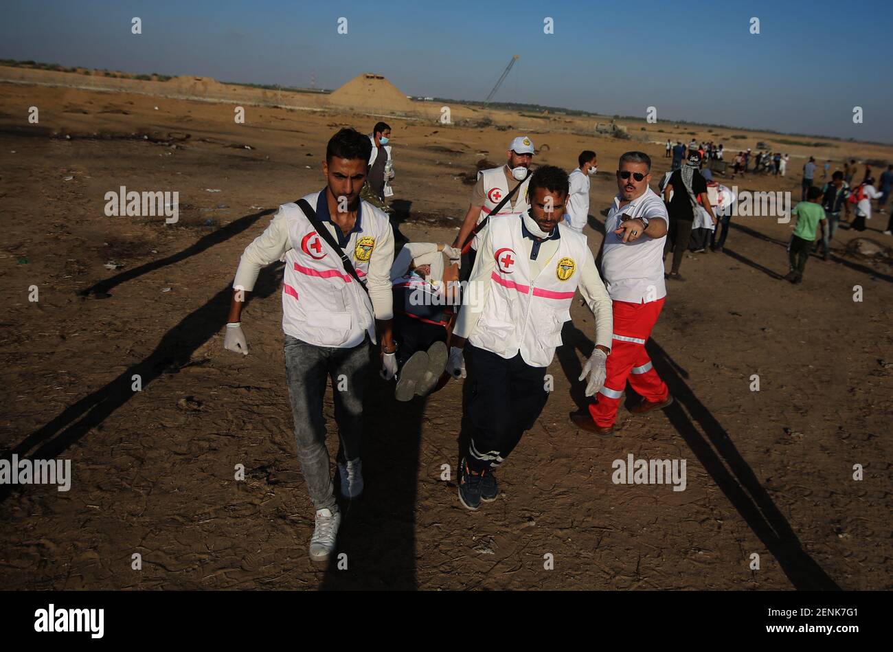 Palestinian medics carry a wounded person during an anti-Israel ...