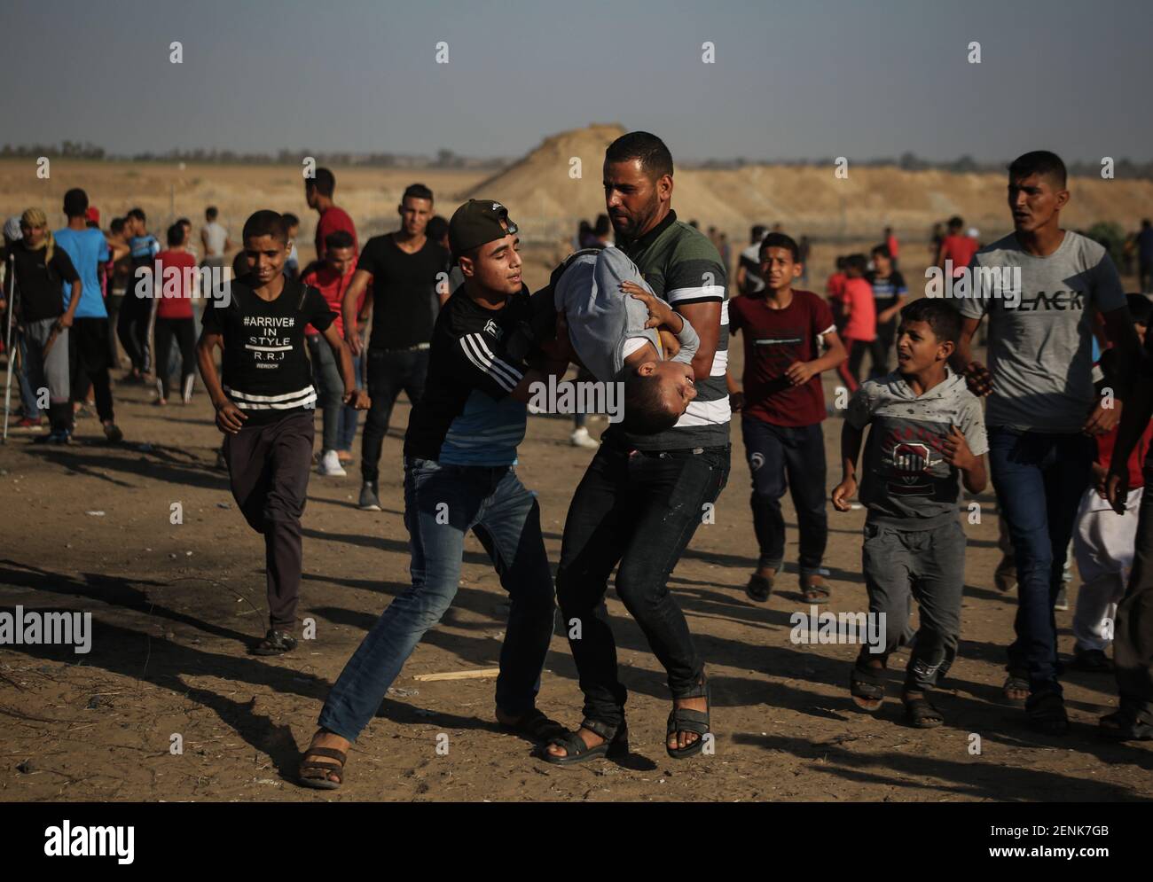 A Palestinian boy is being evacuated during an anti-Israel ...