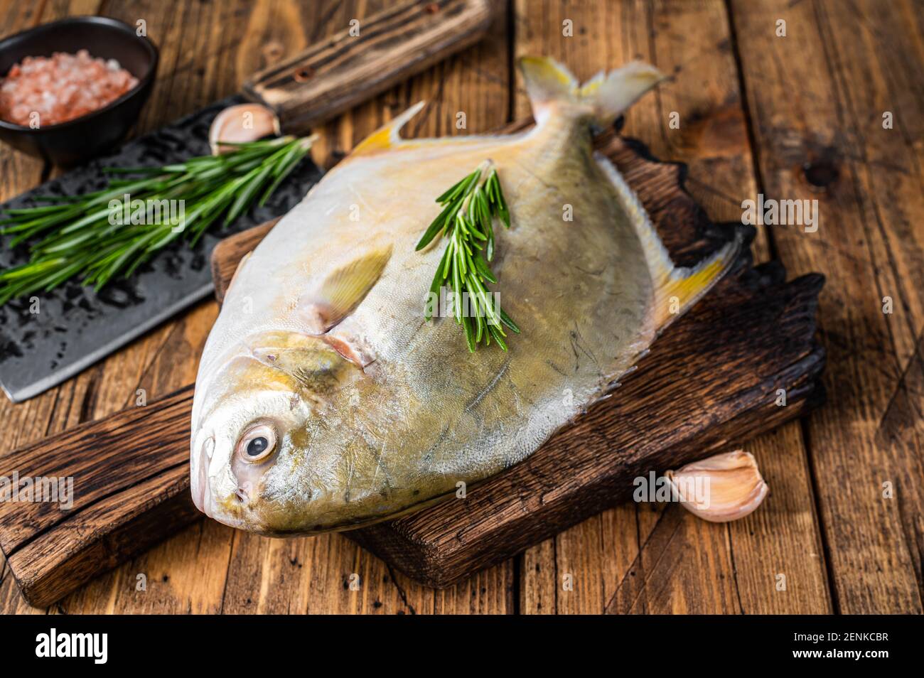 Raw fish Sunfish or pompano on a wooden board. wooden background. Top ...