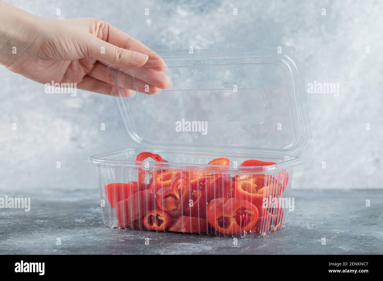 Female hand opening plastic container, Plastic container full Stock ...