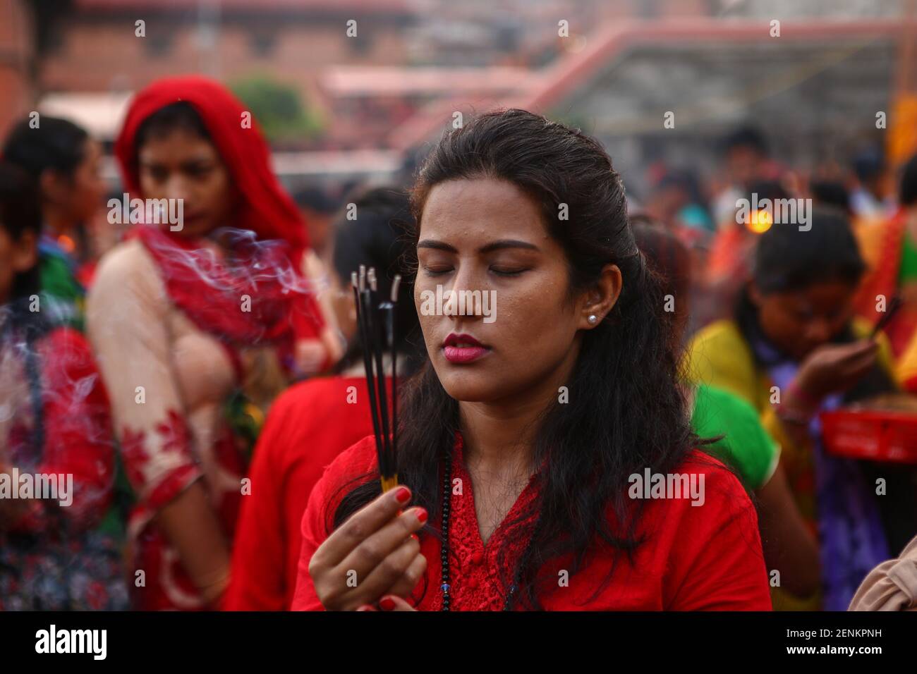 A Nepali Hindu woman offers prayers to Lord Shiva, the Hindu god of ...