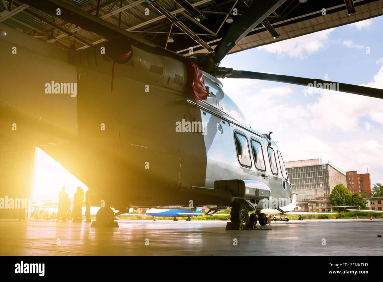 Passenger helicopter in the hangar. Rotorcraft under maintenance ...