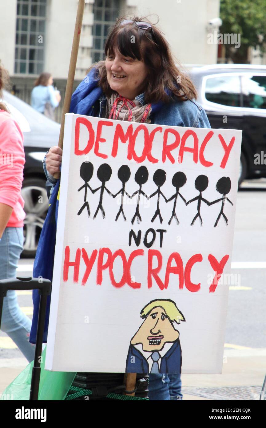 A protester holds a placard saying democracy not hypocracy during the ...