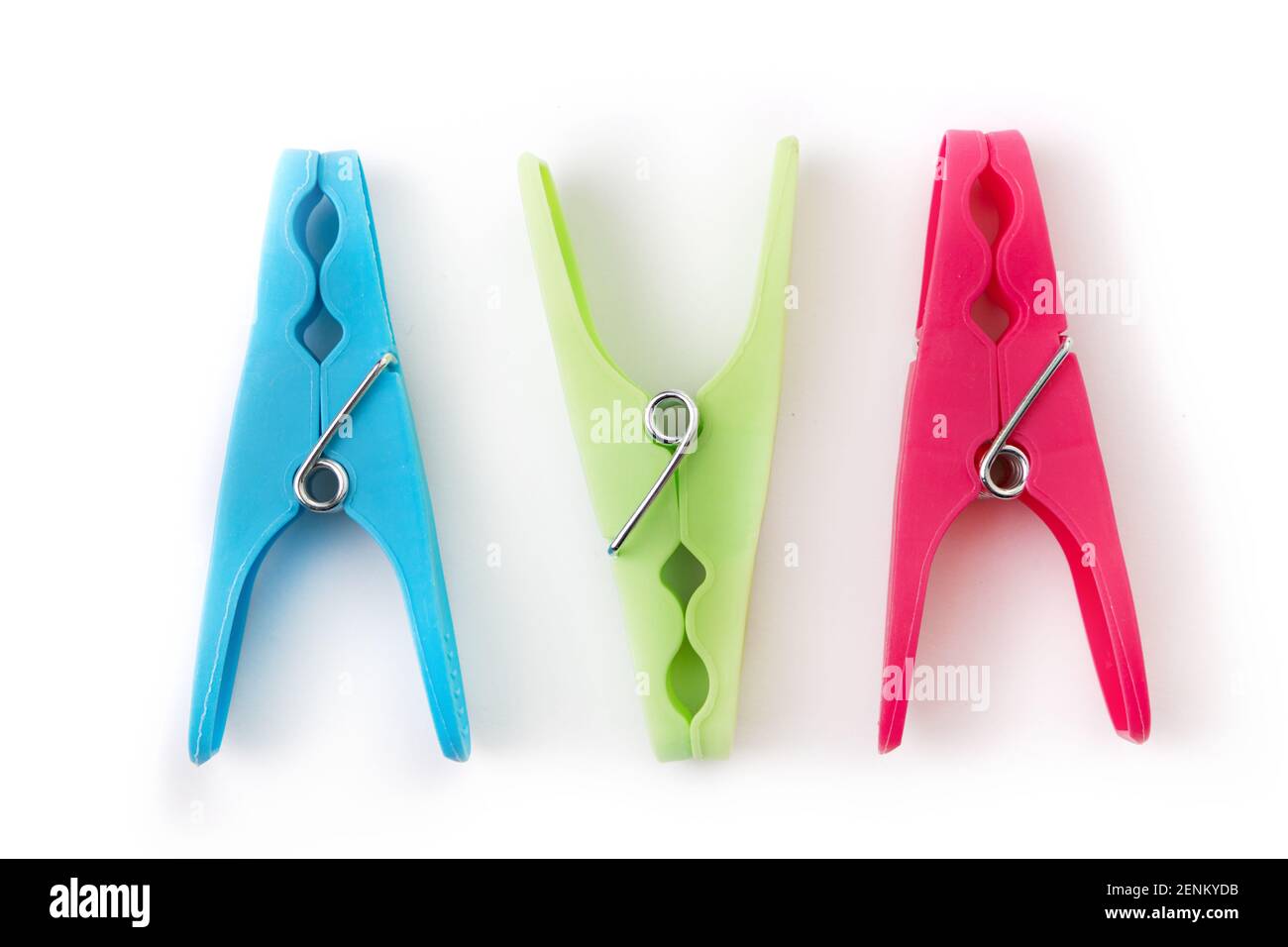 top view of three different color clothespins isolated on white ...