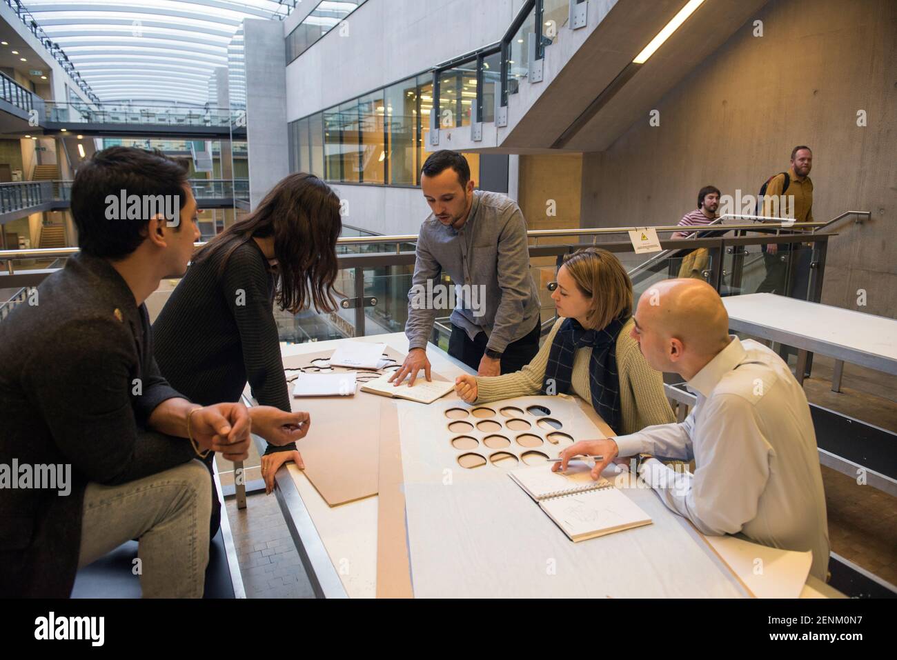 Group of design students having discussion Stock Photo - Alamy