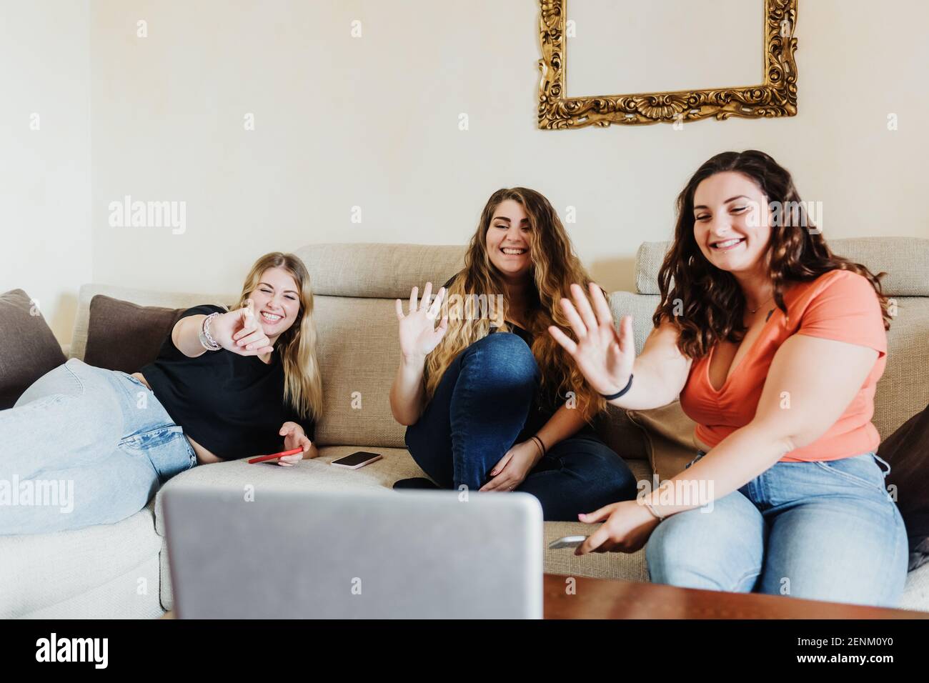 Female friends on video call, waving Stock Photo - Alamy