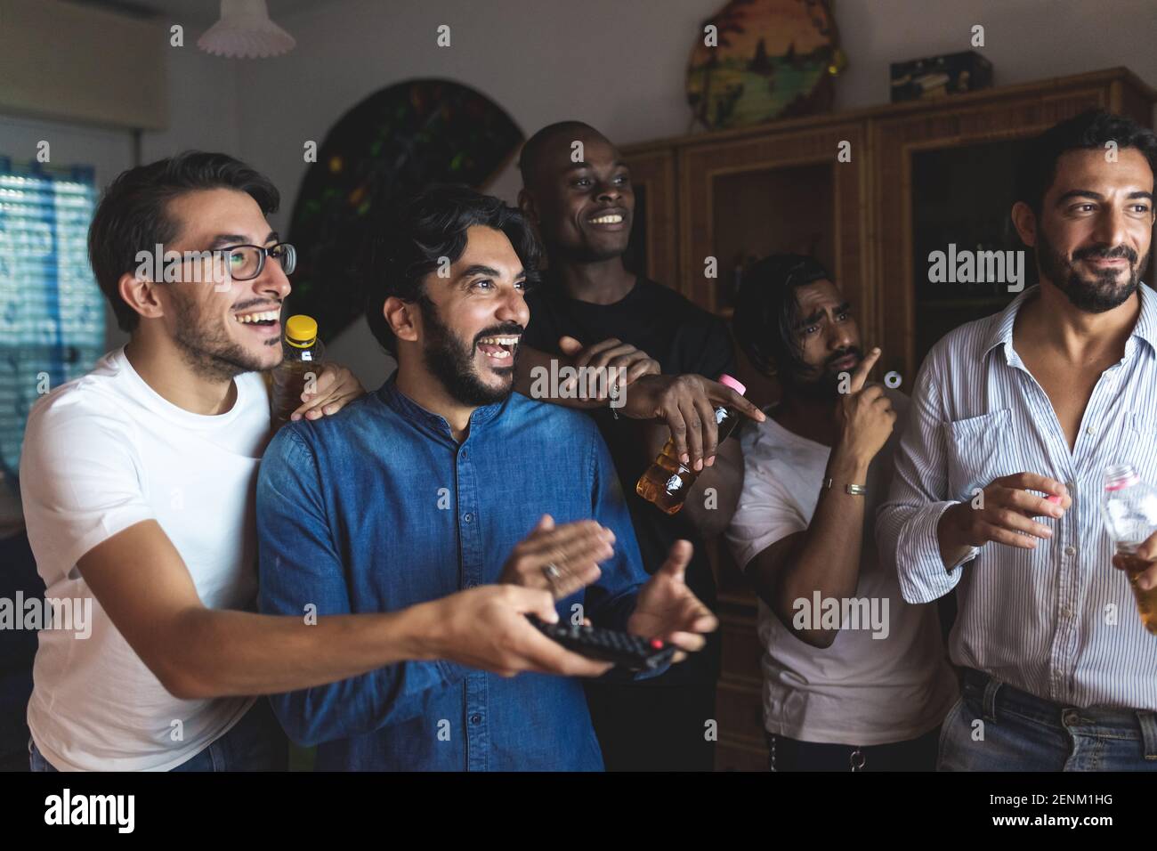 Male friends watching tv together Stock Photo - Alamy