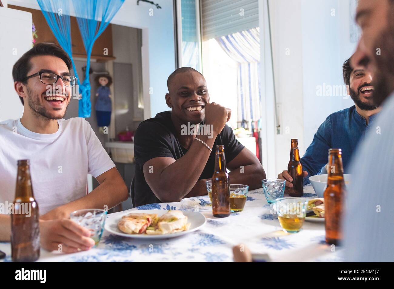 Male friends socialising with food and beer Stock Photo - Alamy