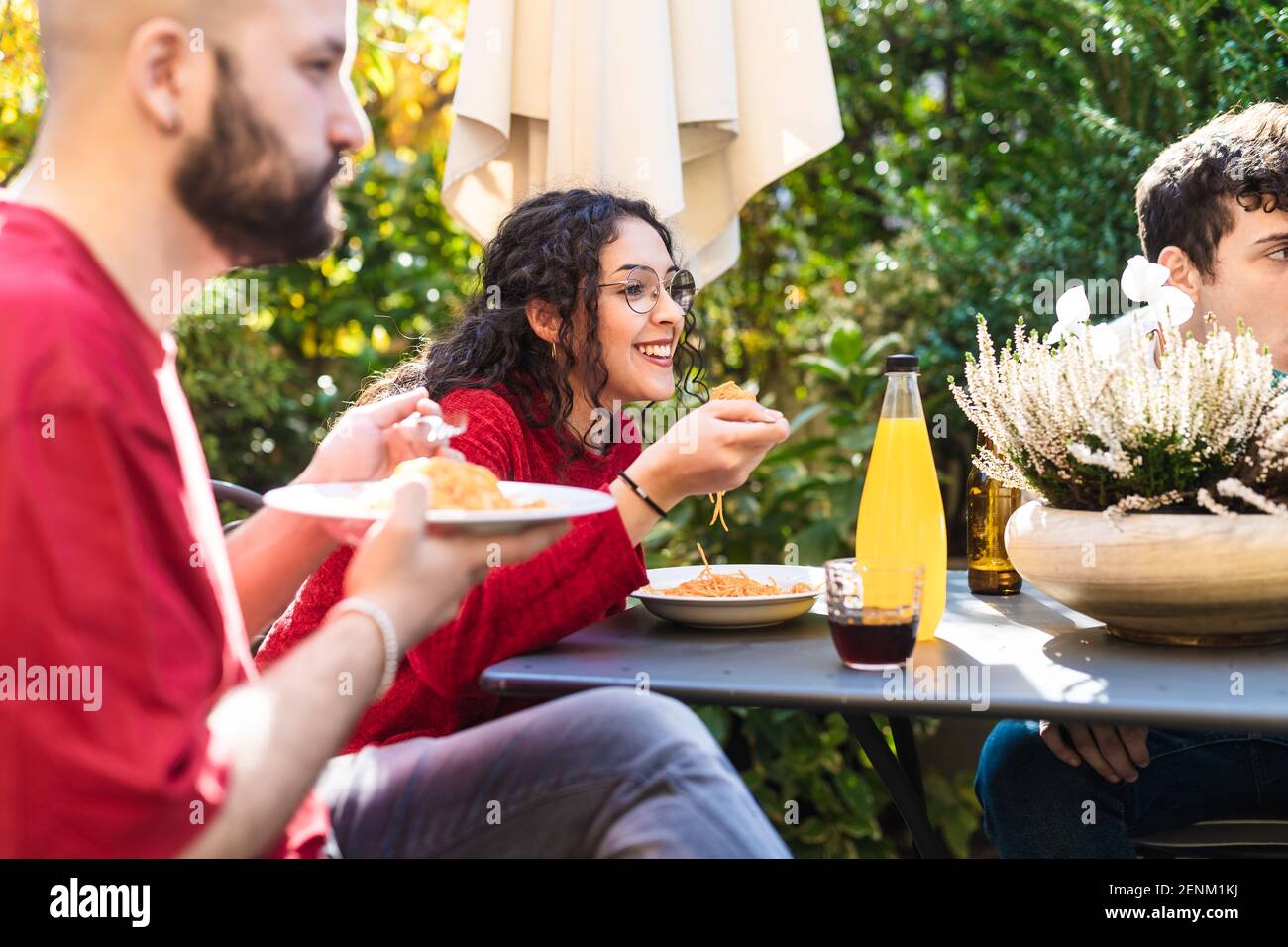 Friends eating meal together outdoors Stock Photo - Alamy