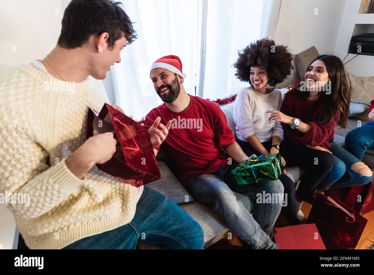 Friends exchanging Christmas gifts Stock Photo - Alamy
