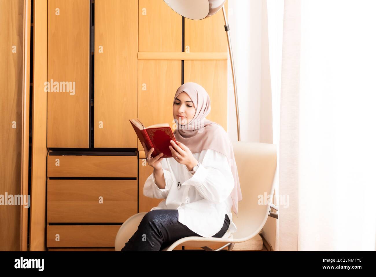 Young muslim woman reading book Stock Photo - Alamy