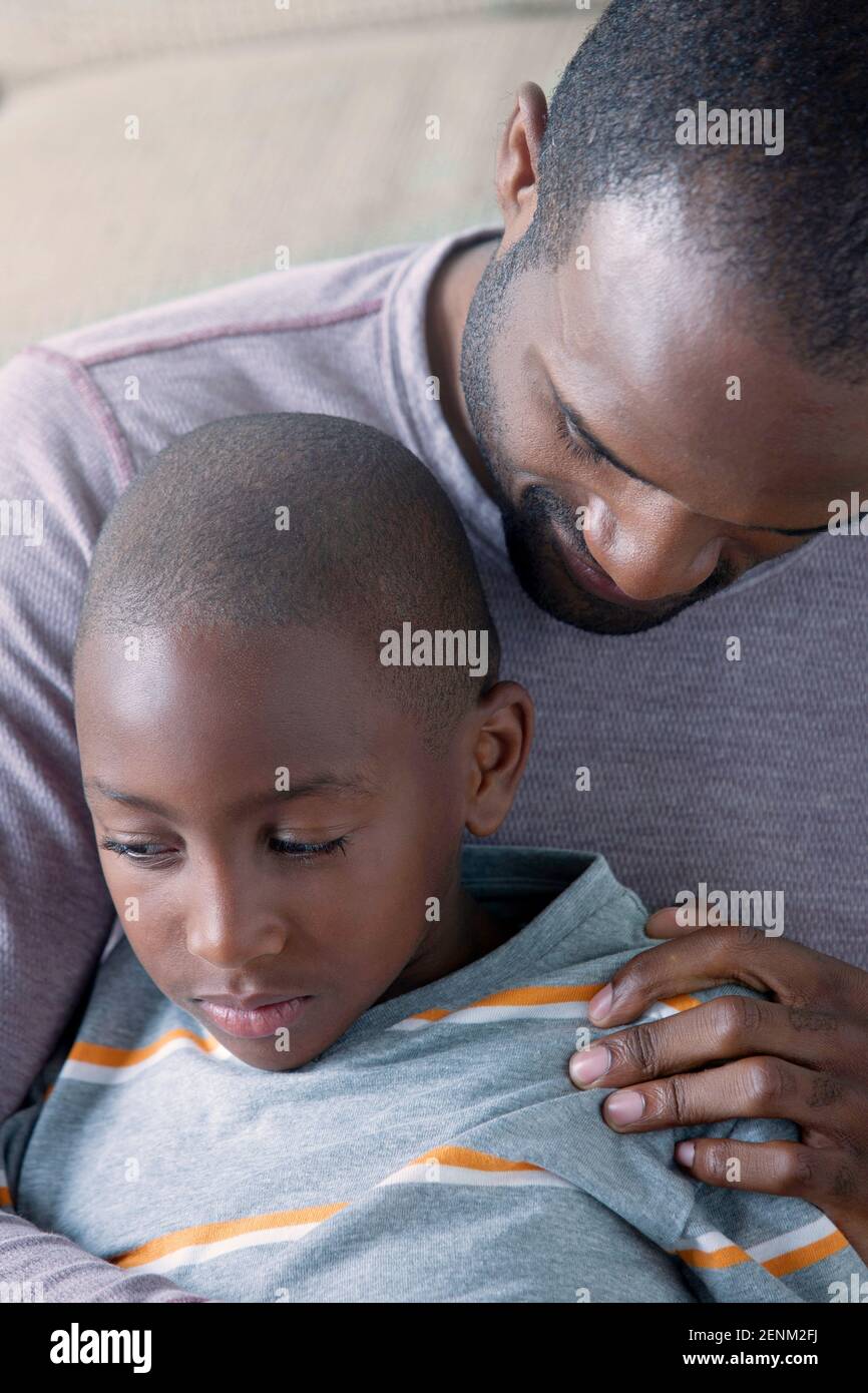Portrait of father comforting sad son Stock Photo - Alamy
