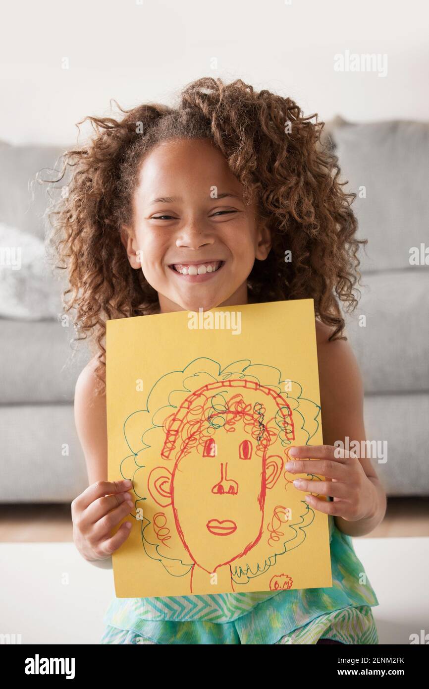 Girl holding a drawing Stock Photo - Alamy