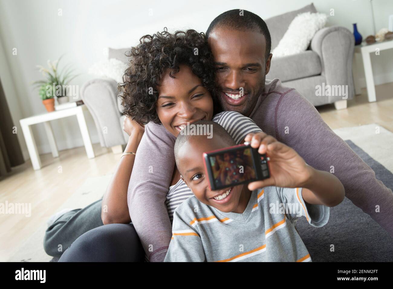 Parents and son photographing themselves with Stock Photo - Alamy