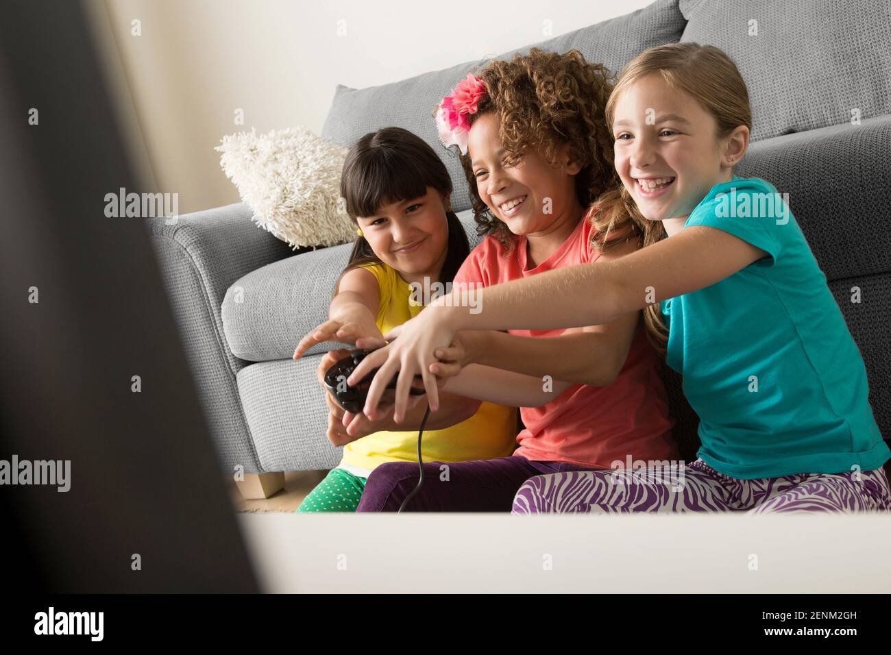 Three girls playing video game Stock Photo - Alamy