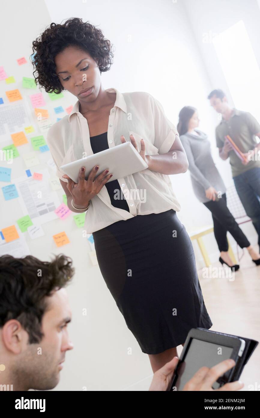 Office workers using digital tablets Stock Photo - Alamy