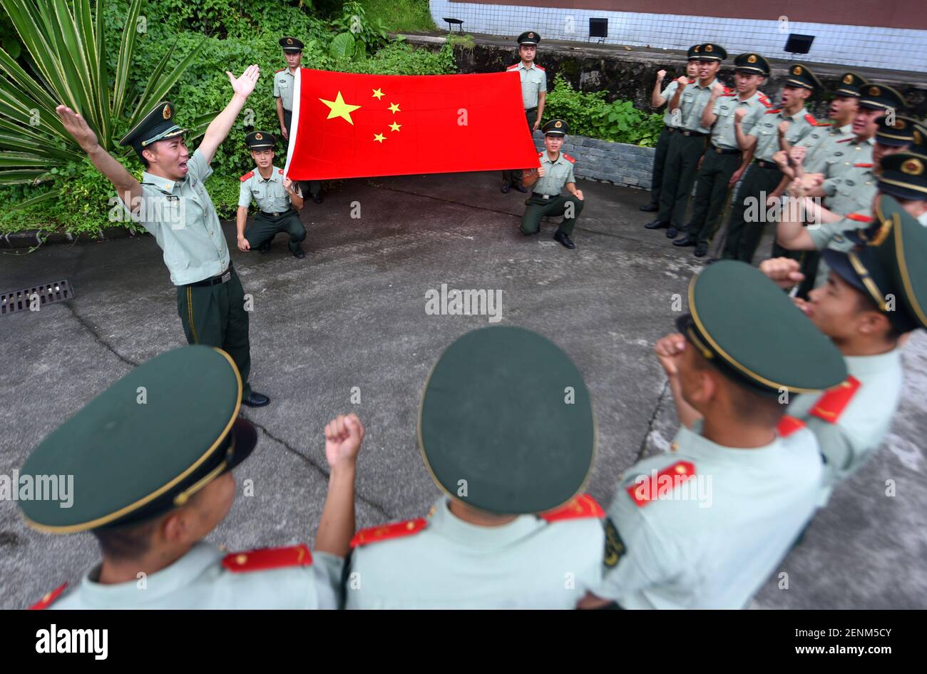 Chinese paramilitary policemen of the local armed police force sing ...