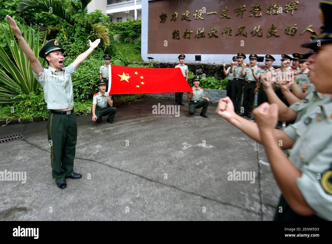 Chinese paramilitary policemen of the local armed police force sing ...