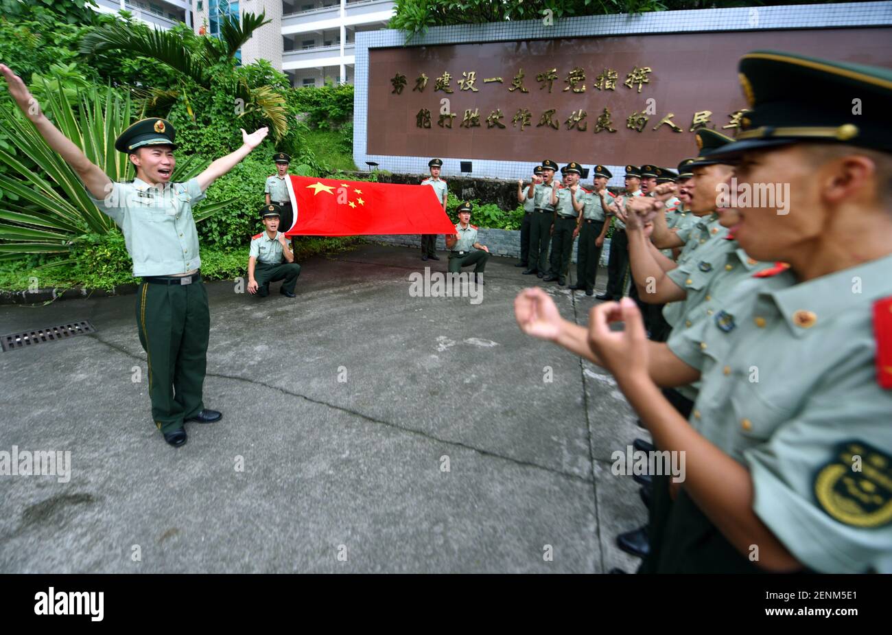 Chinese paramilitary policemen of the local armed police force sing ...