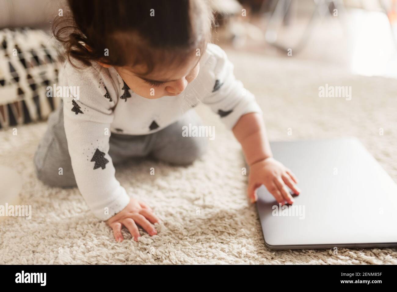 Cute boy on the floor touching laptop Stock Photo - Alamy