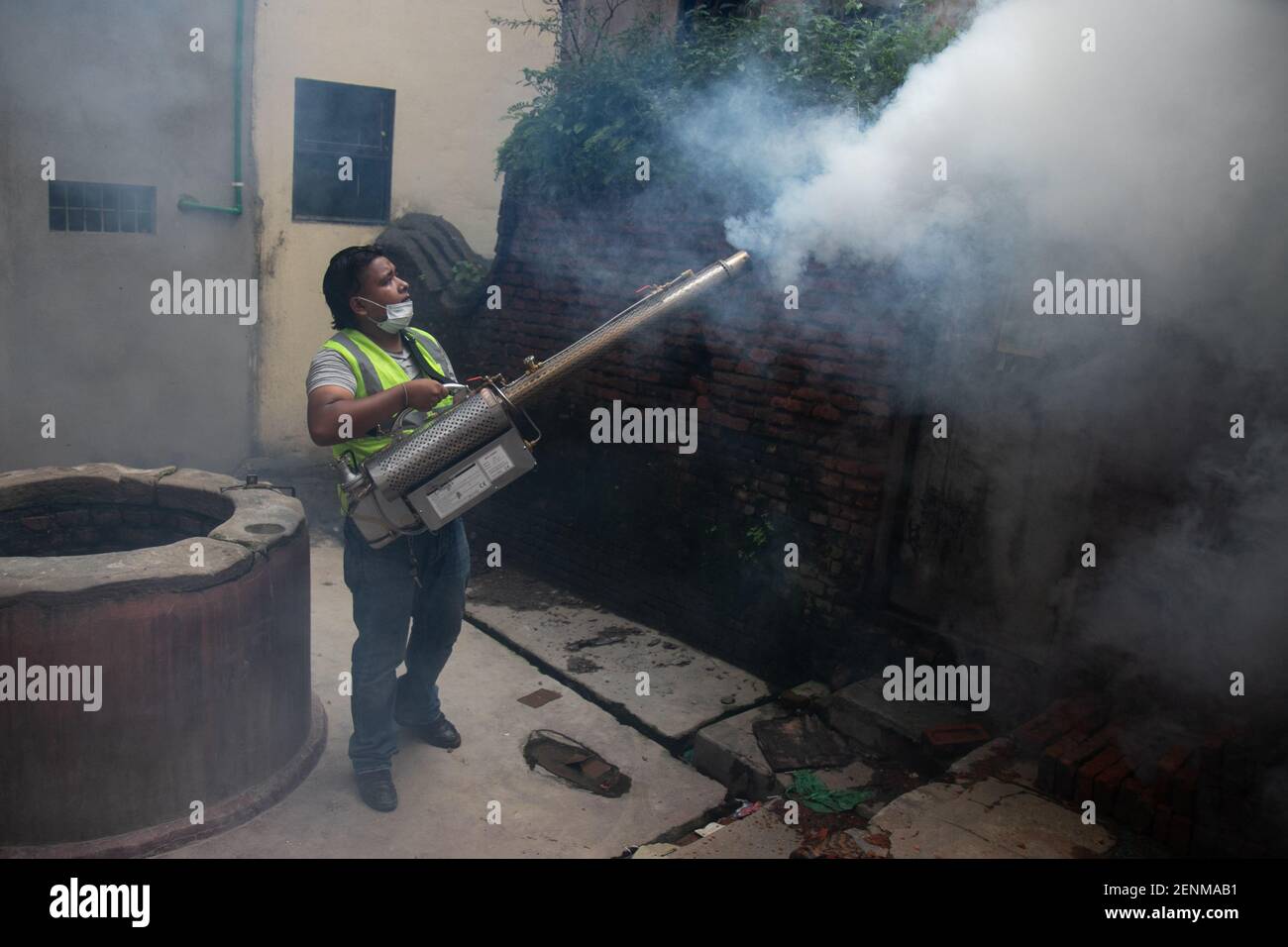 A member of Korean Disinfection Crupee Team fumigates the area to kill ...