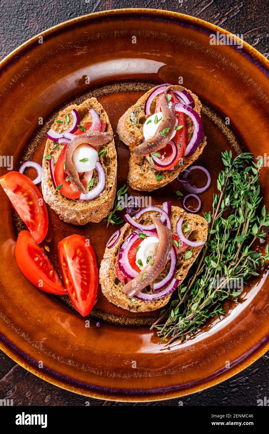 Spanish tapas on bread with olive oil, herbs, tomatoes and spicy ...