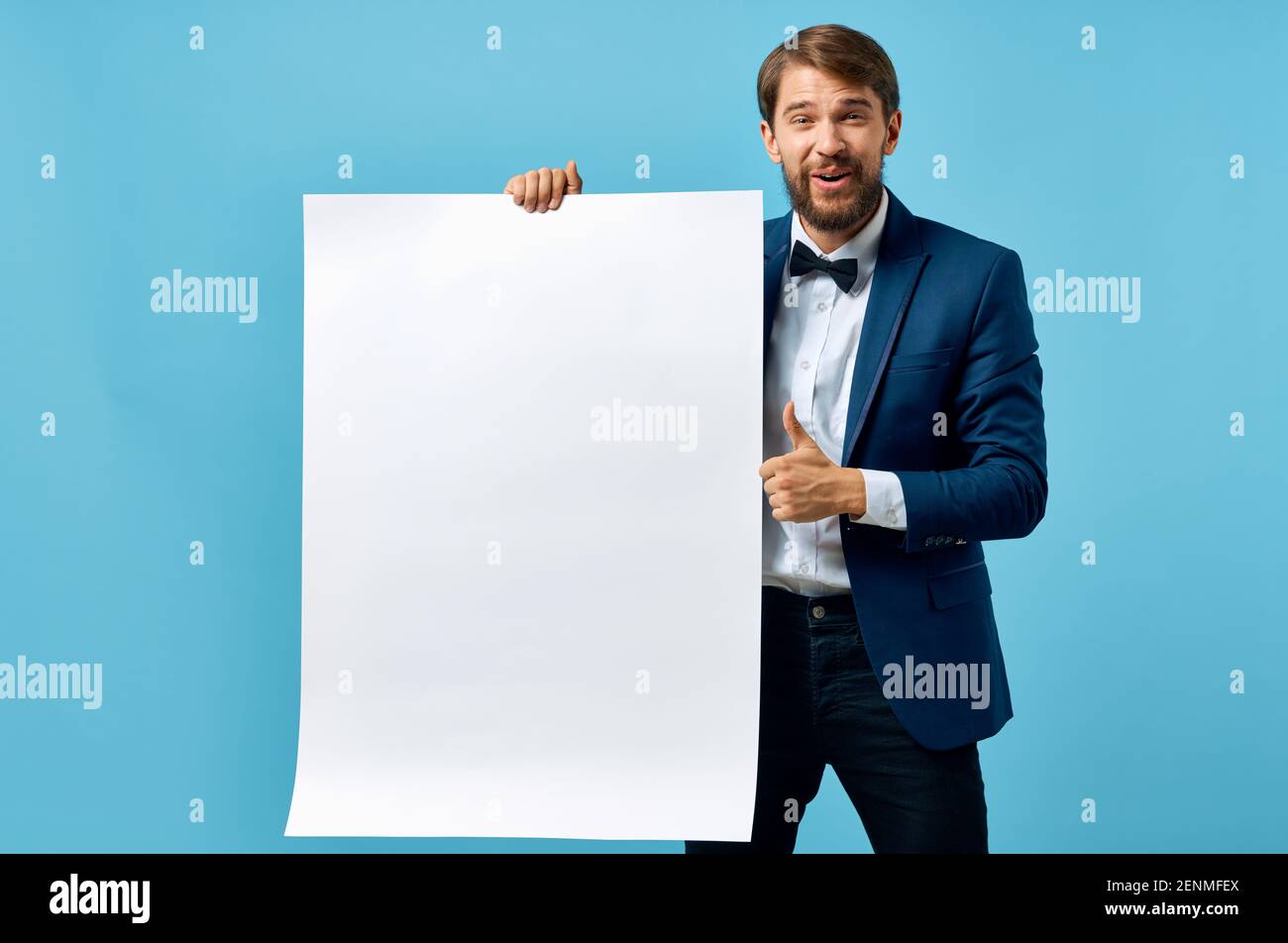 a man in a suit holding a banner in front of him advertising ...