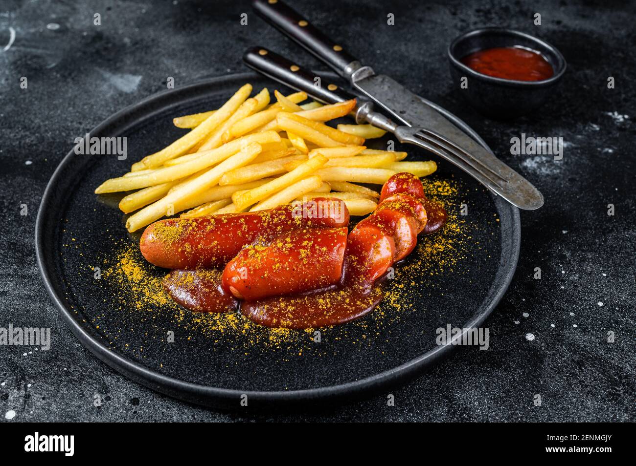 Traditional German currywurst, served with French fries. Black ...