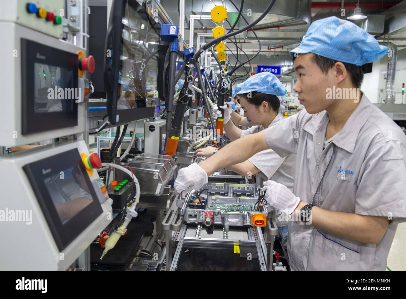 Chinese workers assemble batteries for electric vehicles at the plant ...