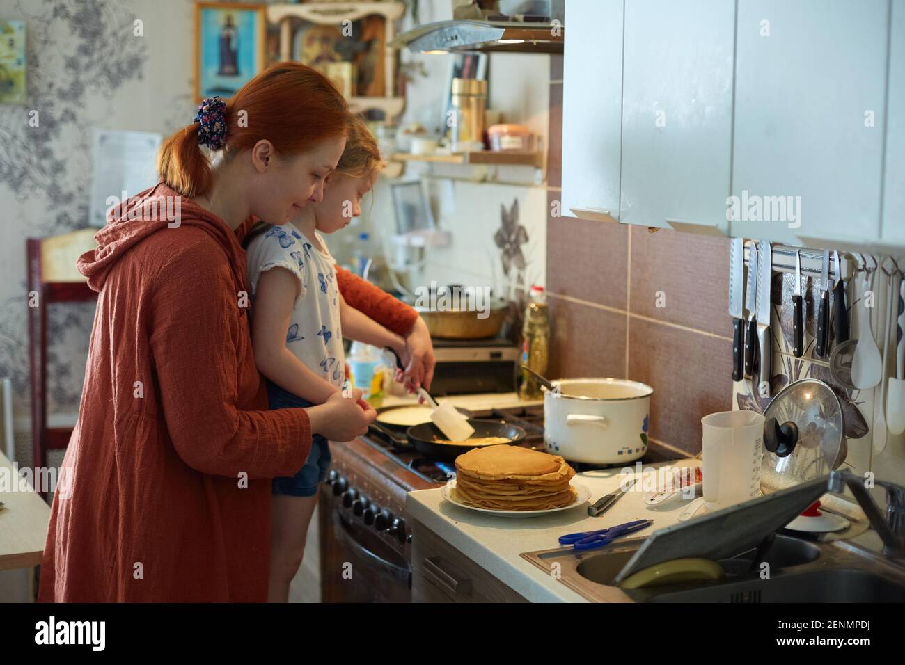mom and daughter bake pancakes in the kitchen Stock Photo - Alamy