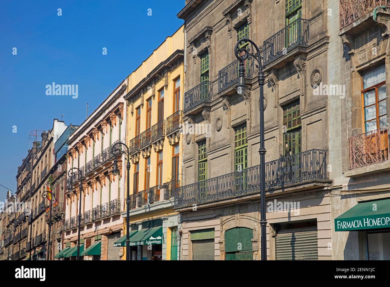 Spanish colonial buildings and storefronts on the Calle Tacuba in ...