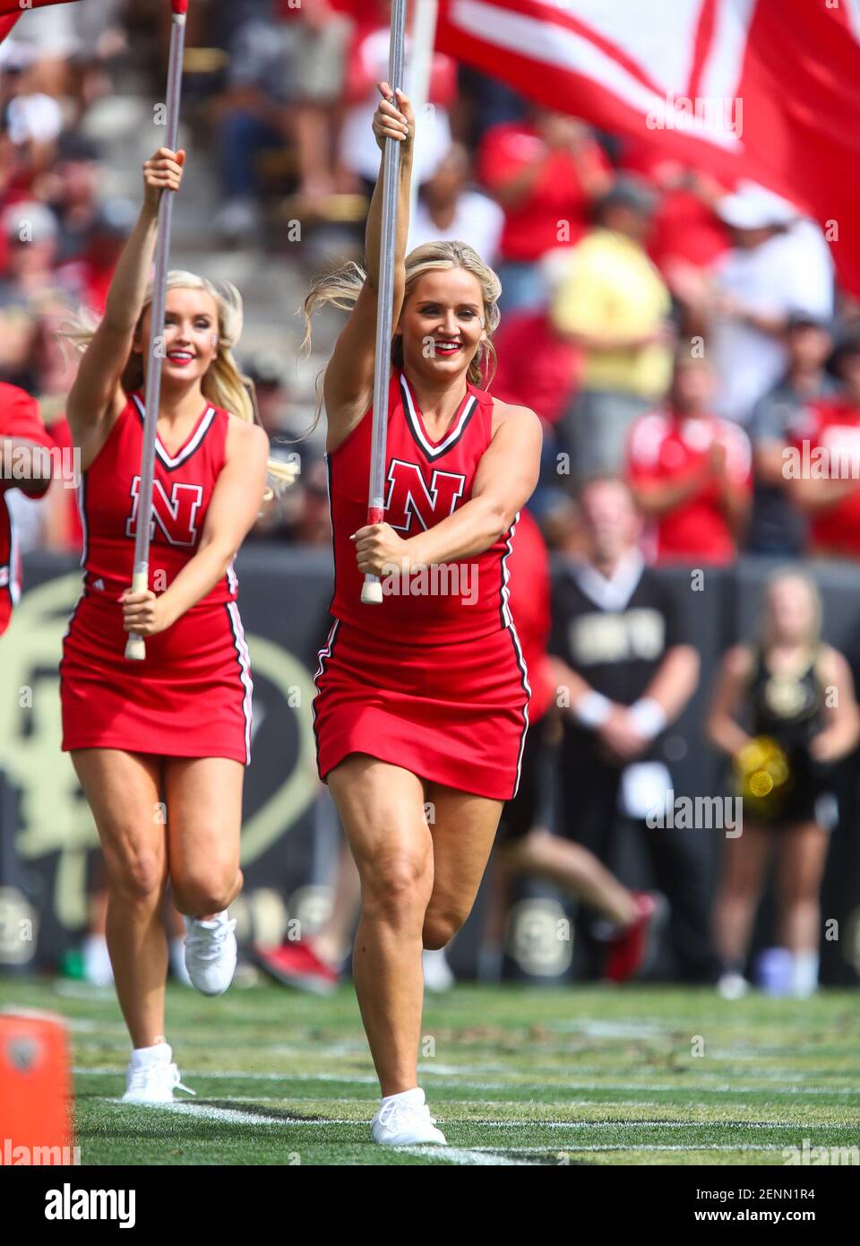 September 7, 2019: Nebraska cheerleaders run team flags onto the field ...