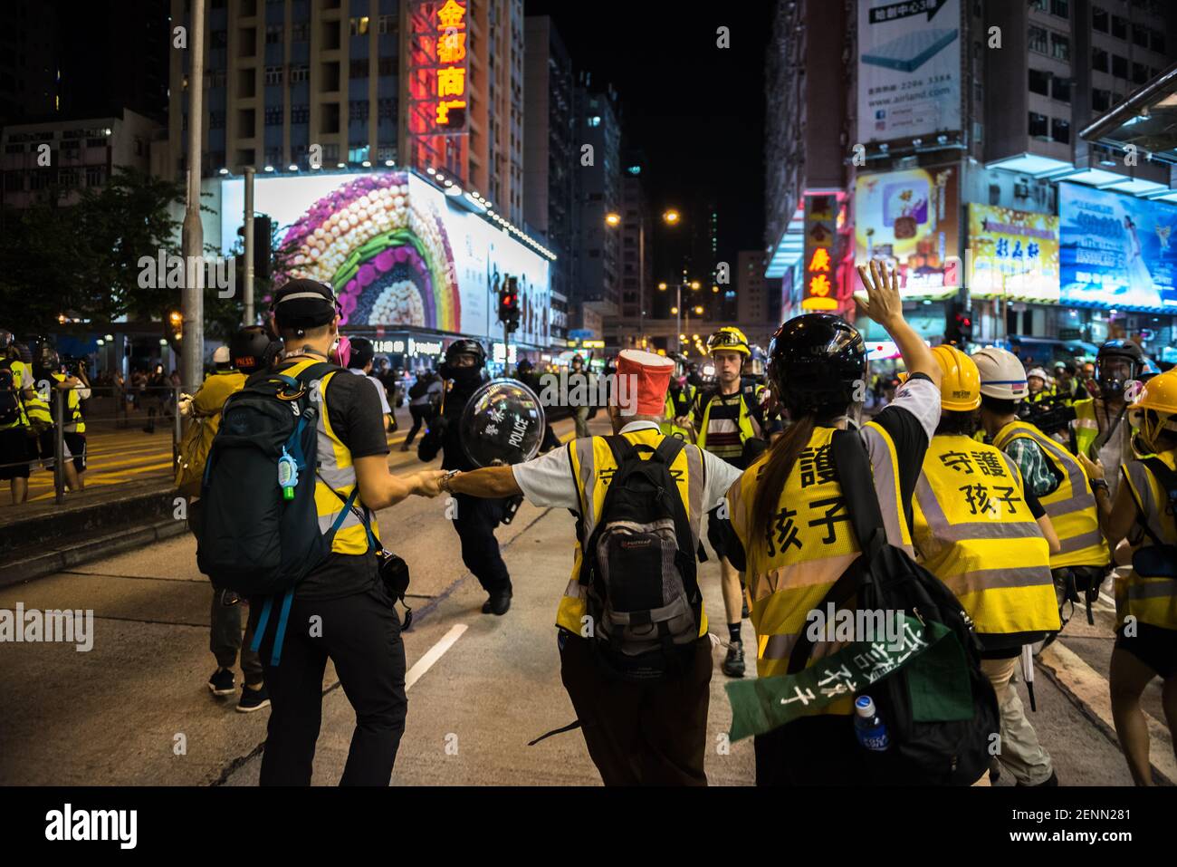 An elderly group aimed at protecting young protesters steps in between ...