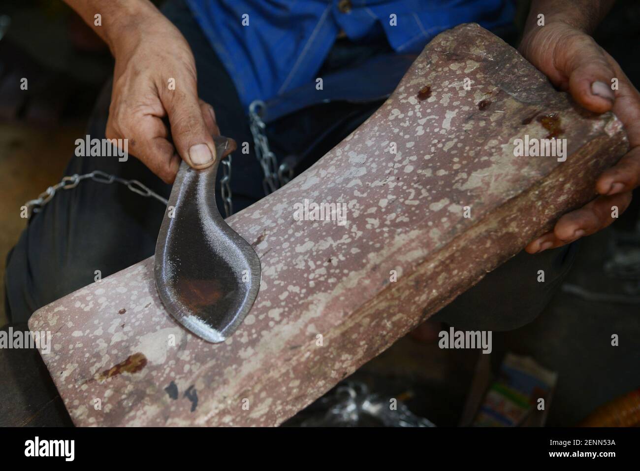 Pakistani Shiite Muslim select knives attached to chains that are used ...