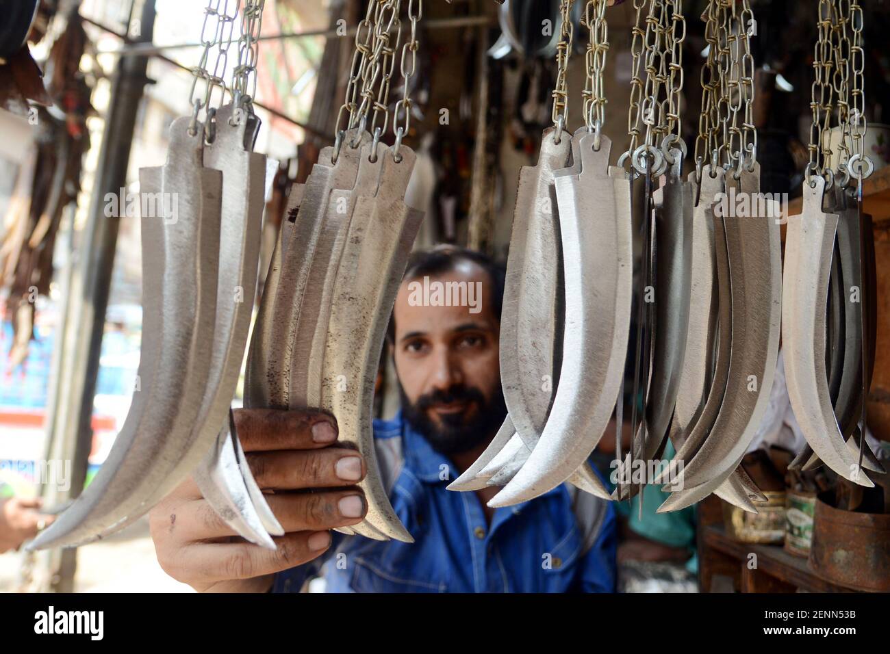 Pakistani Shiite Muslim select knives attached to chains that are used ...