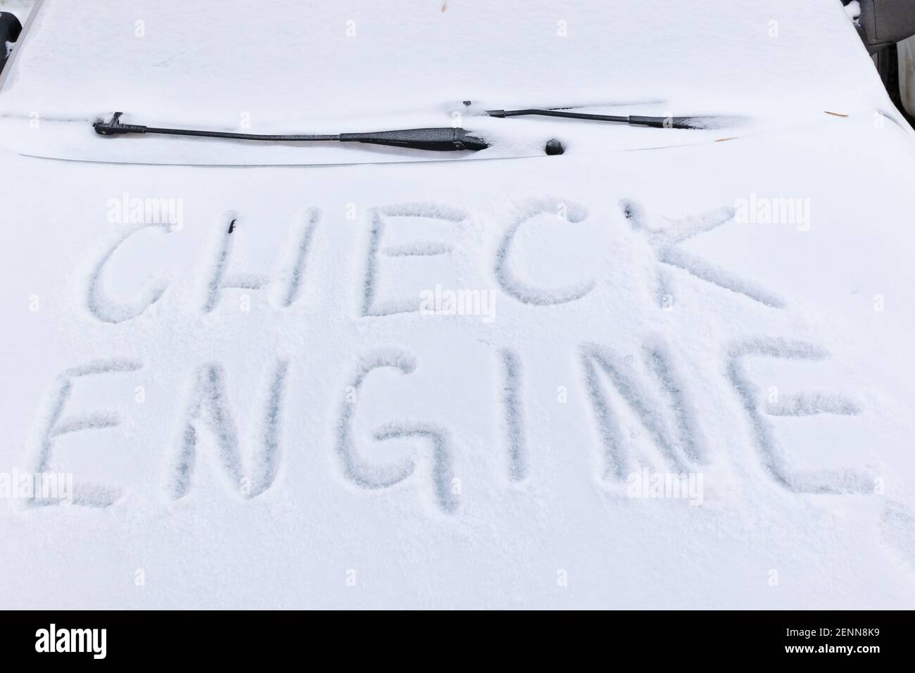 the inscription on the hood of a frozen broken car covered with snow ...
