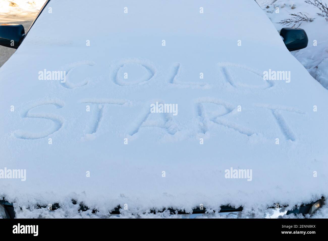 the inscription on the hood of a frozen broken car covered with snow ...