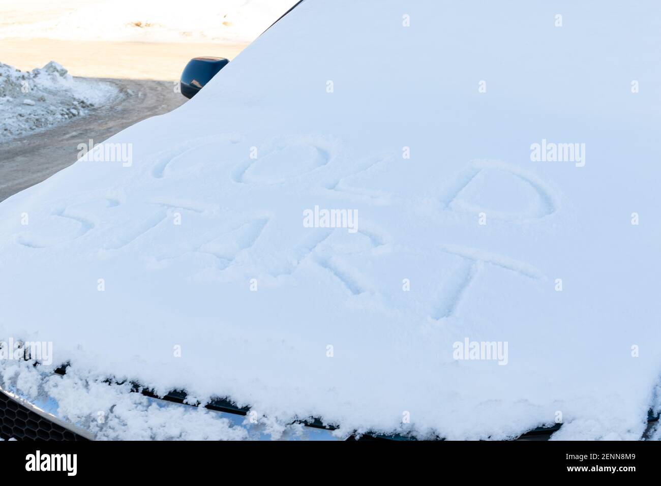 the inscription on the hood of a frozen broken car covered with snow ...