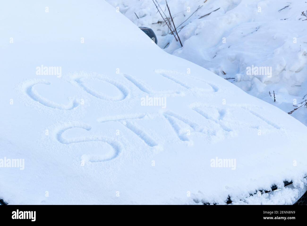 the inscription on the hood of a frozen broken car covered with snow ...