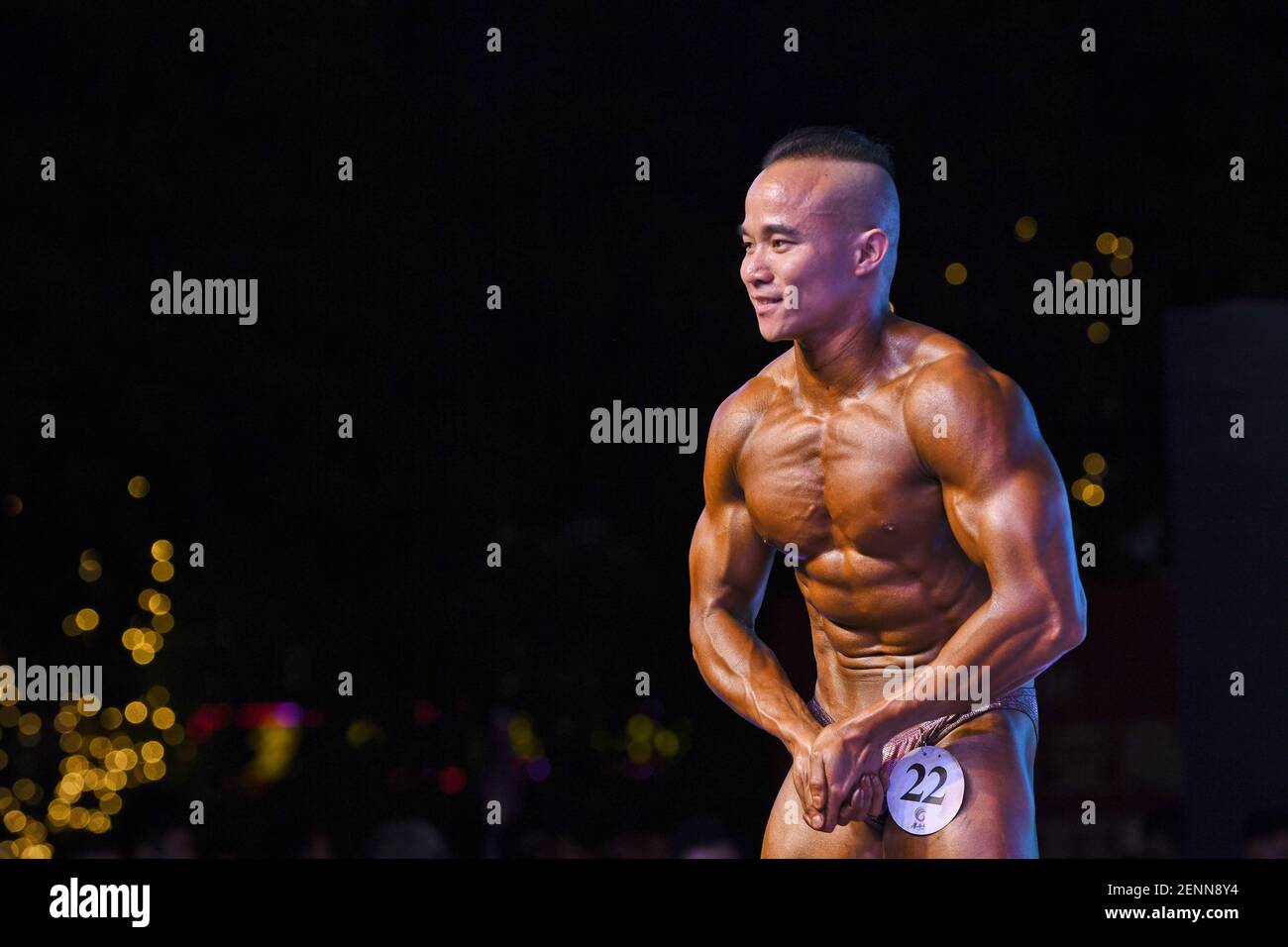 Guangxi,CHINA-On September 8, 2019, men covered with bronze olive oil ...