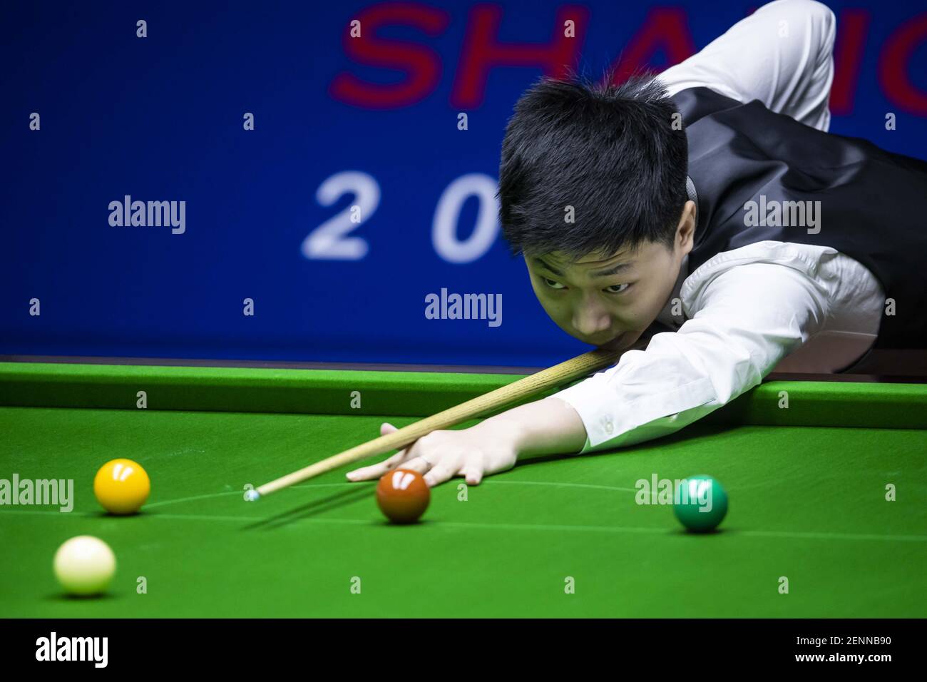 Chinese professional snooker player Wu Haotian plays a shot at the Round 1 of 2019 Snooker ...