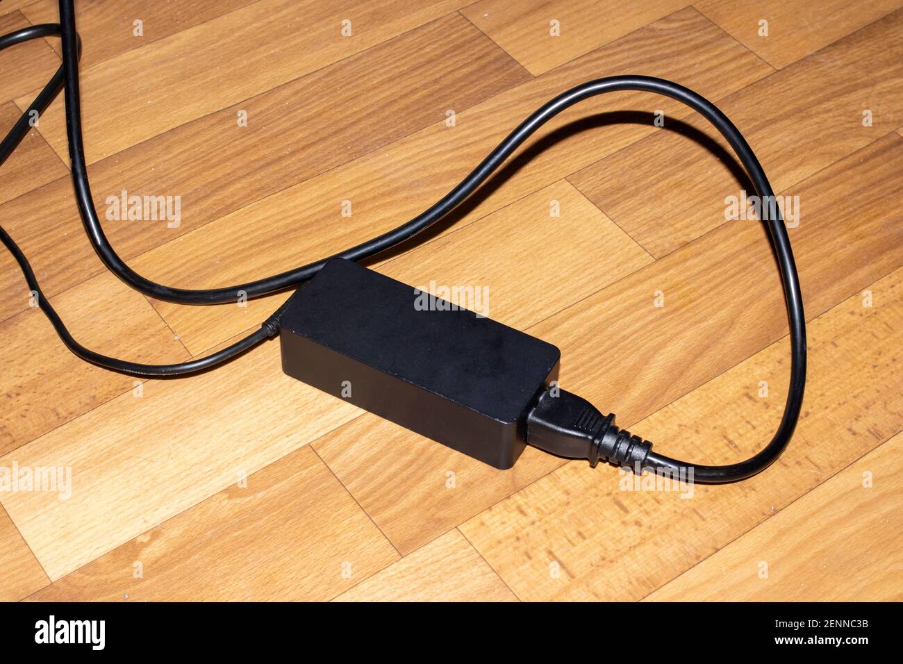 Black extension cord with button and wires on wooden floor Stock Photo ...