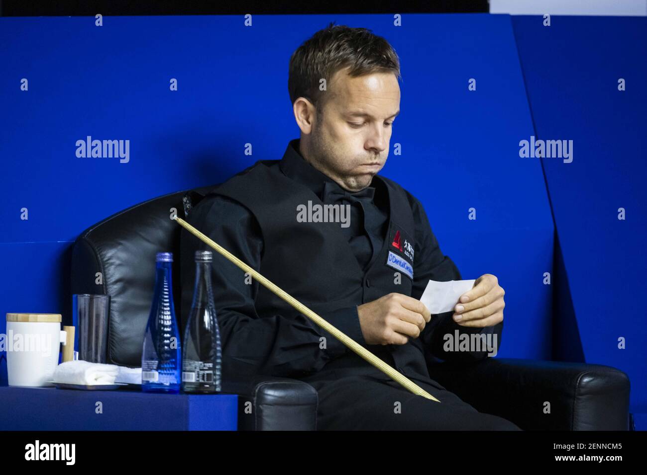 English professional snooker player Allister Carter reads a note at the ...